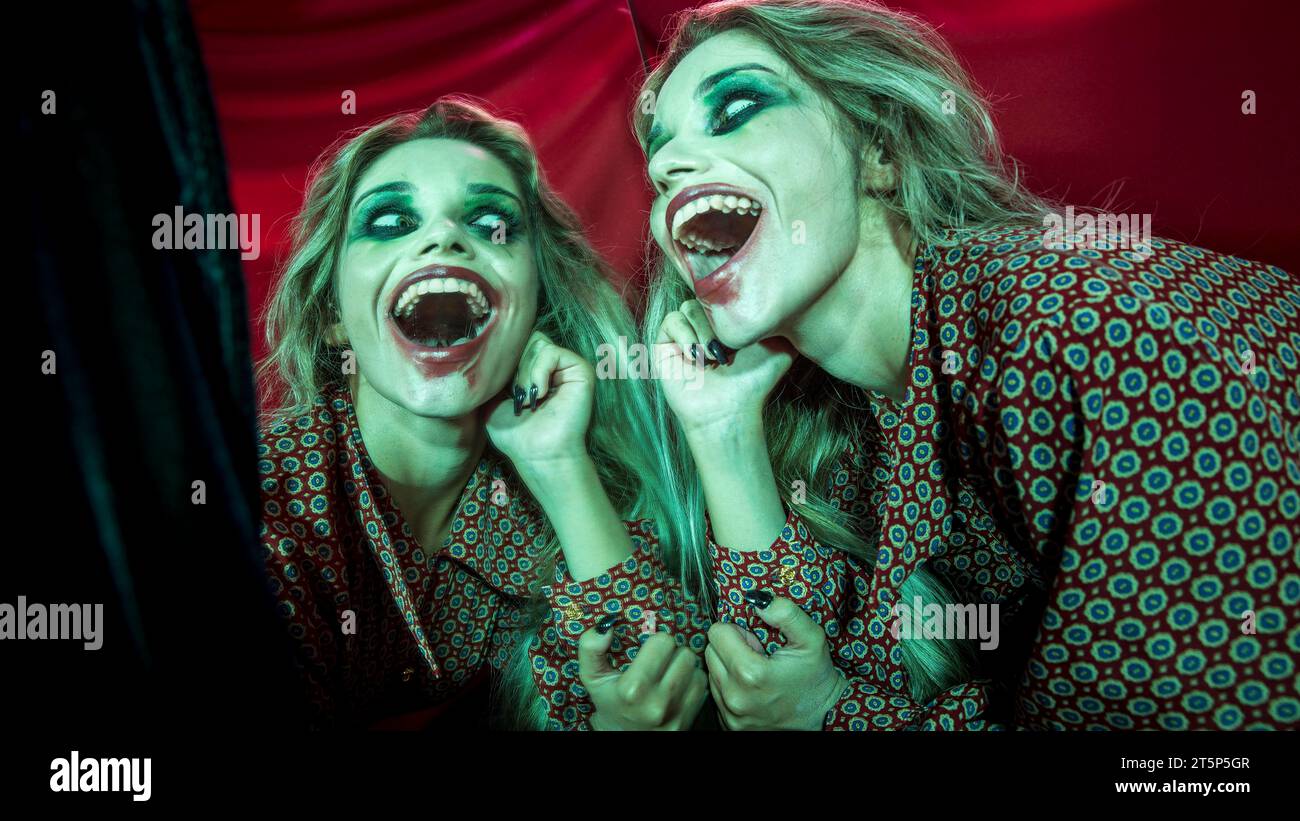 Multiple mirror effect woman having creepy laugh Stock Photo - Alamy