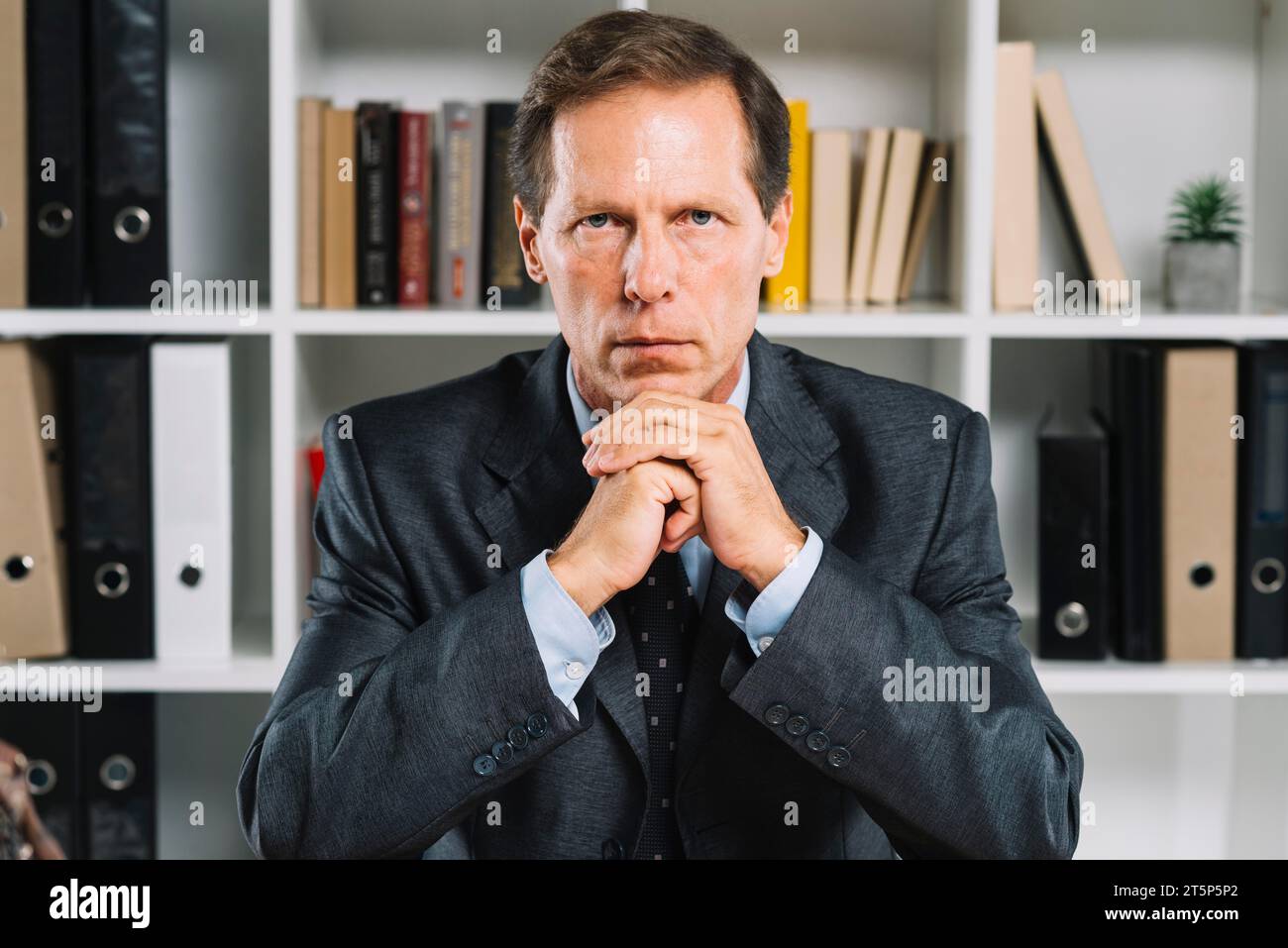 Portrait contemplated mature businessman Stock Photo - Alamy