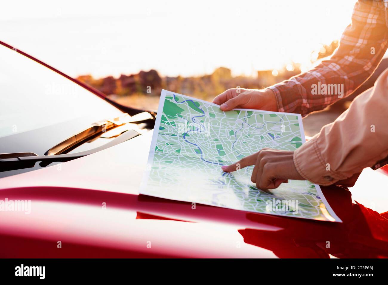 Side view man woman checking map Stock Photo - Alamy