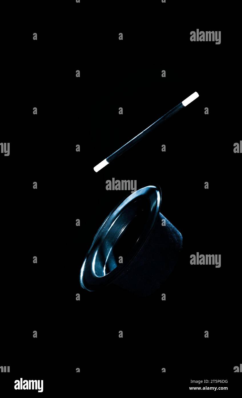 Top black hat magic wand air against black background Stock Photo - Alamy