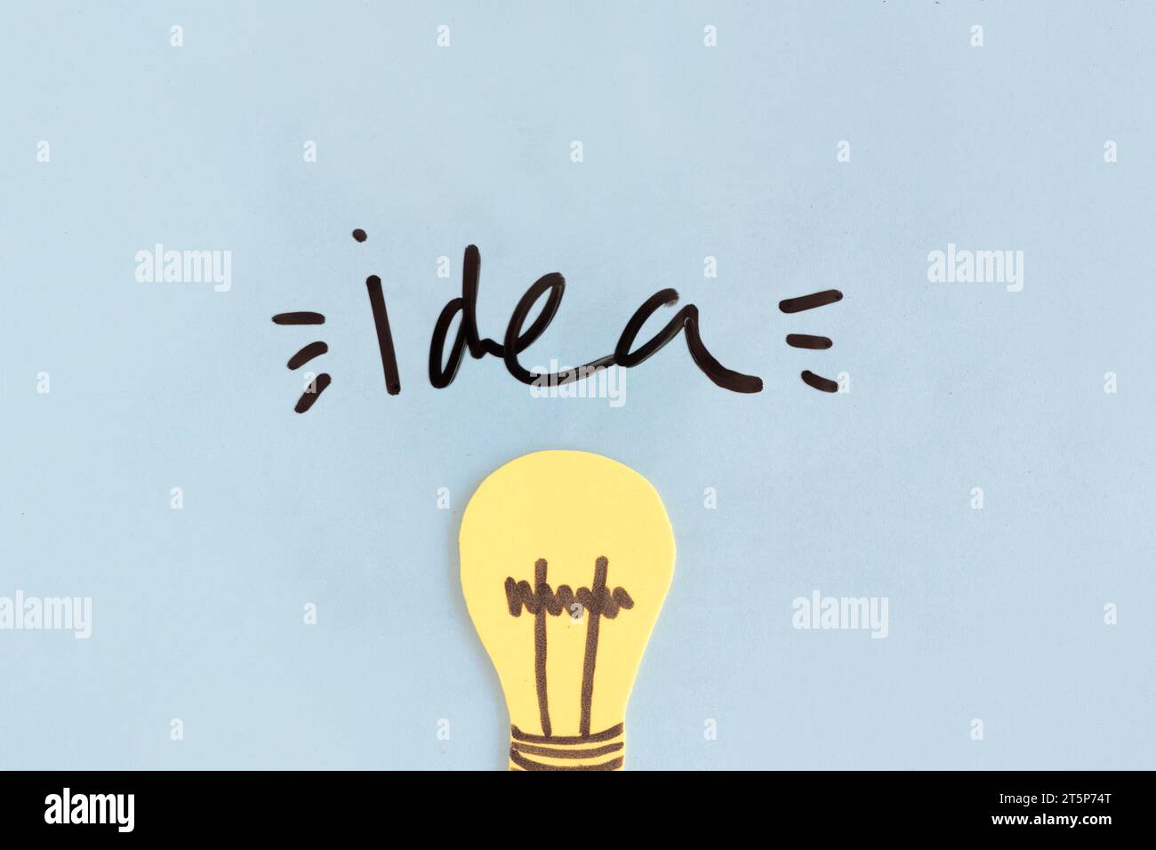 Yellow light bulb with idea word blue background Stock Photo - Alamy
