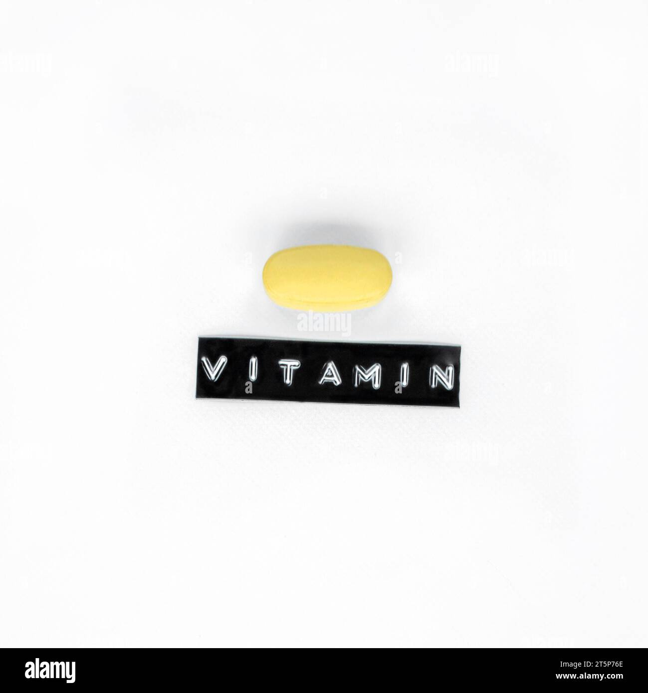 Yellow vitamin pill isolated white background Stock Photo - Alamy