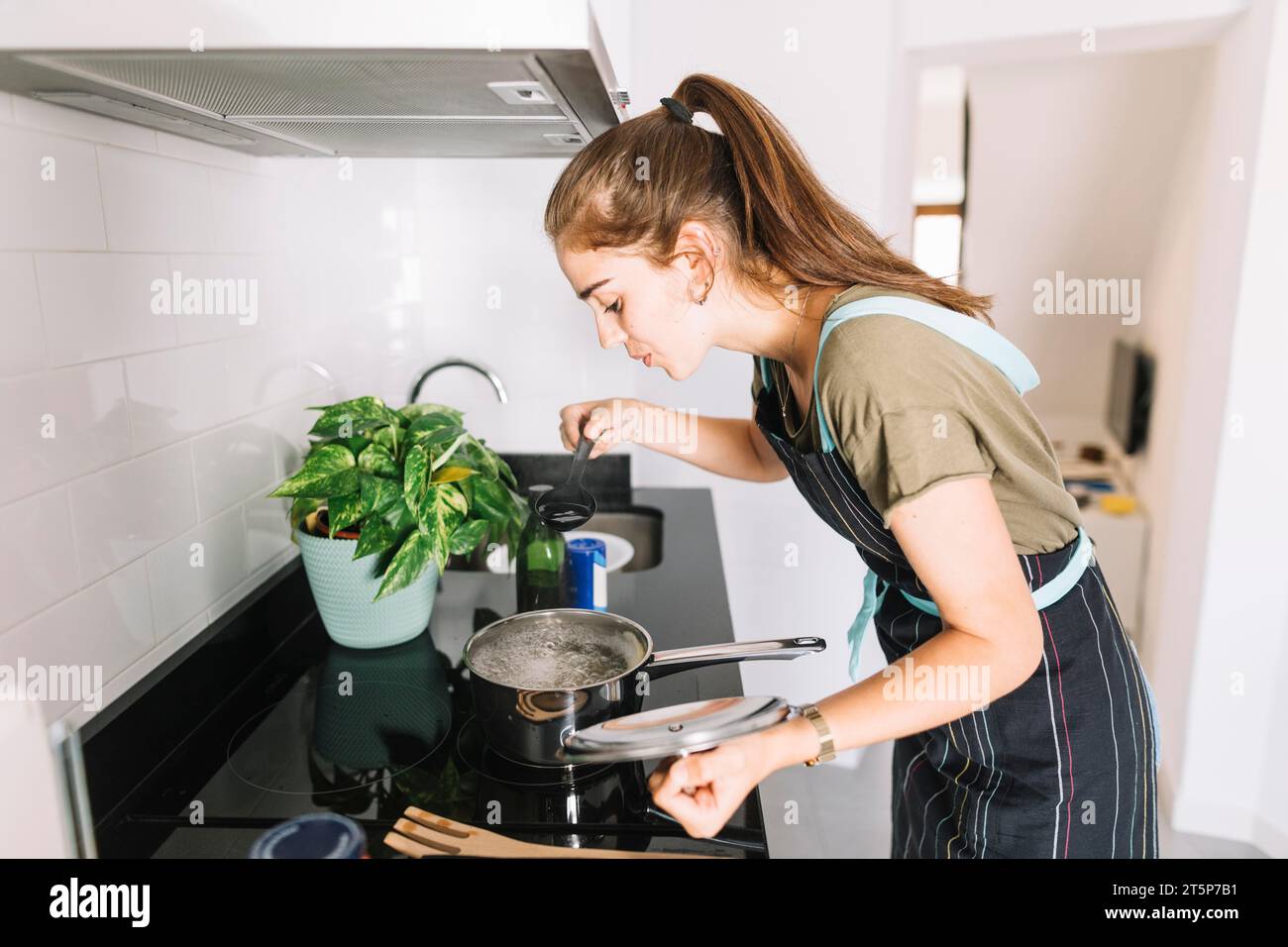 Young woman tasting salad hi-res stock photography and images - Alamy