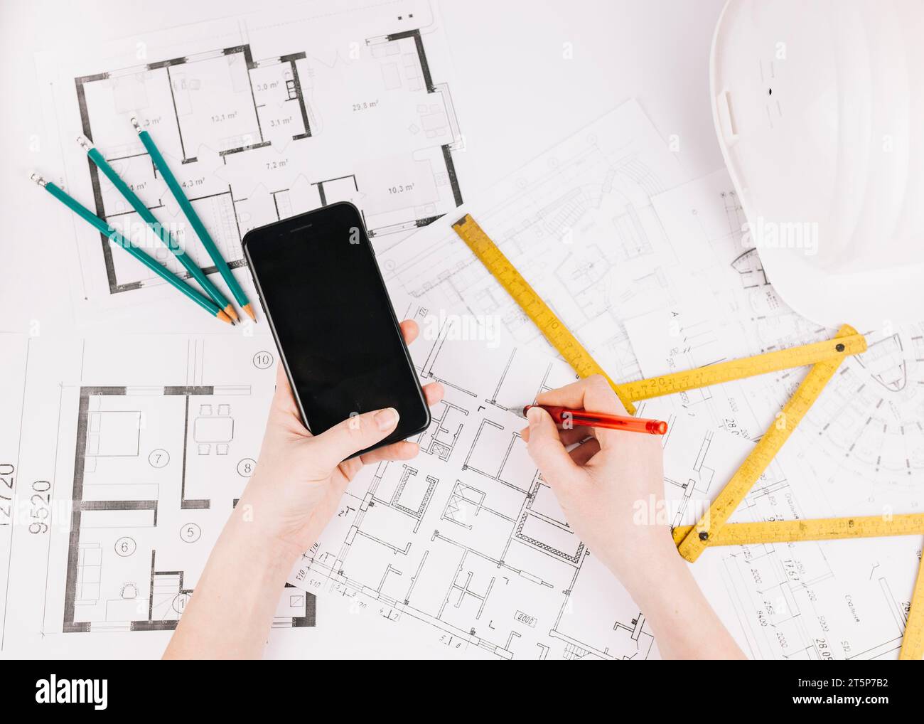 Architecture concept with building plan smartphone Stock Photo - Alamy