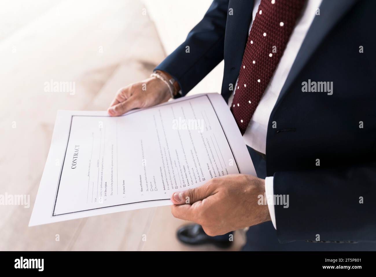 Close up man suit holding contract Stock Photo - Alamy