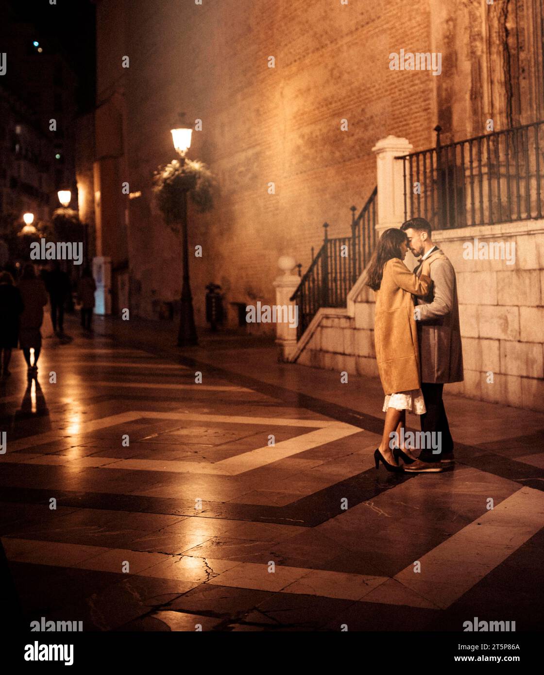 Elegant lady hugging kissing with young guy street Stock Photo - Alamy