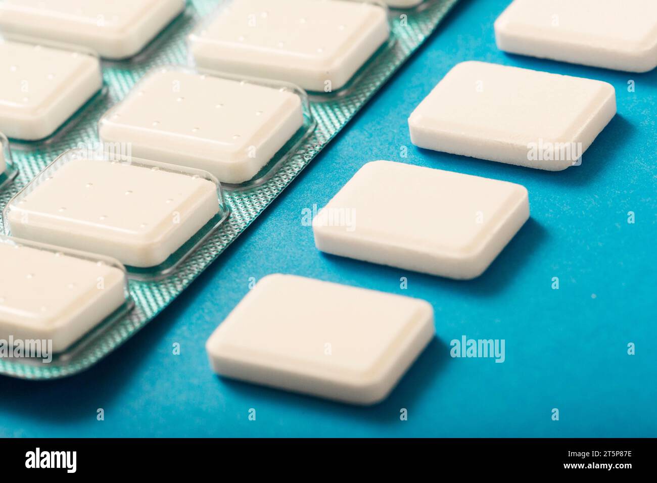 Detail chewing gum blister blue backdrop Stock Photo - Alamy