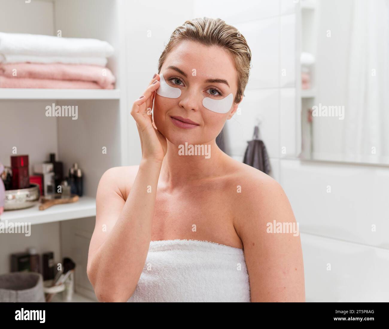 Female having eye bags treatment patches Stock Photo - Alamy