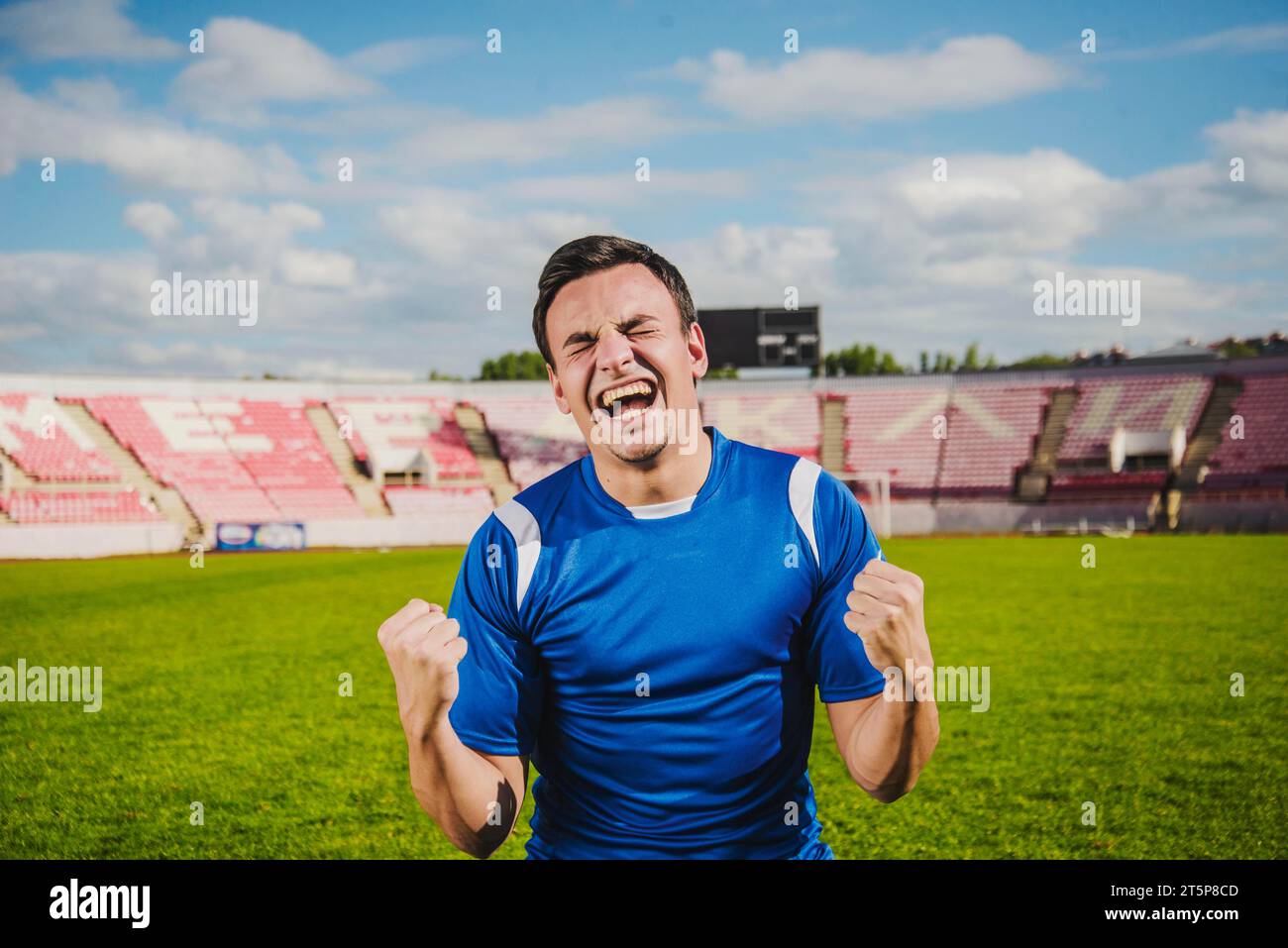 Football player celebrating win Stock Photo - Alamy