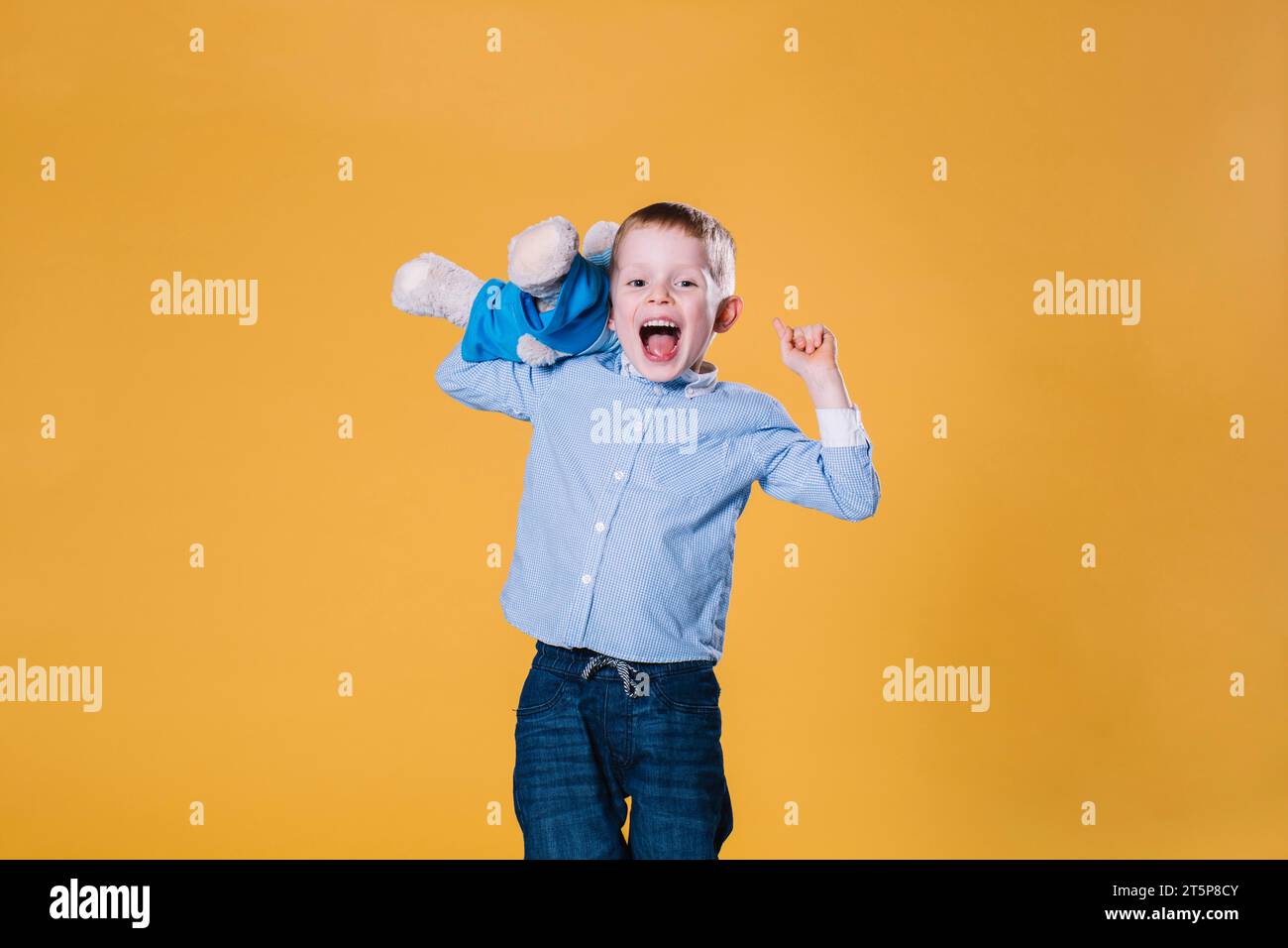 Excited boy with teddy bear Stock Photo - Alamy