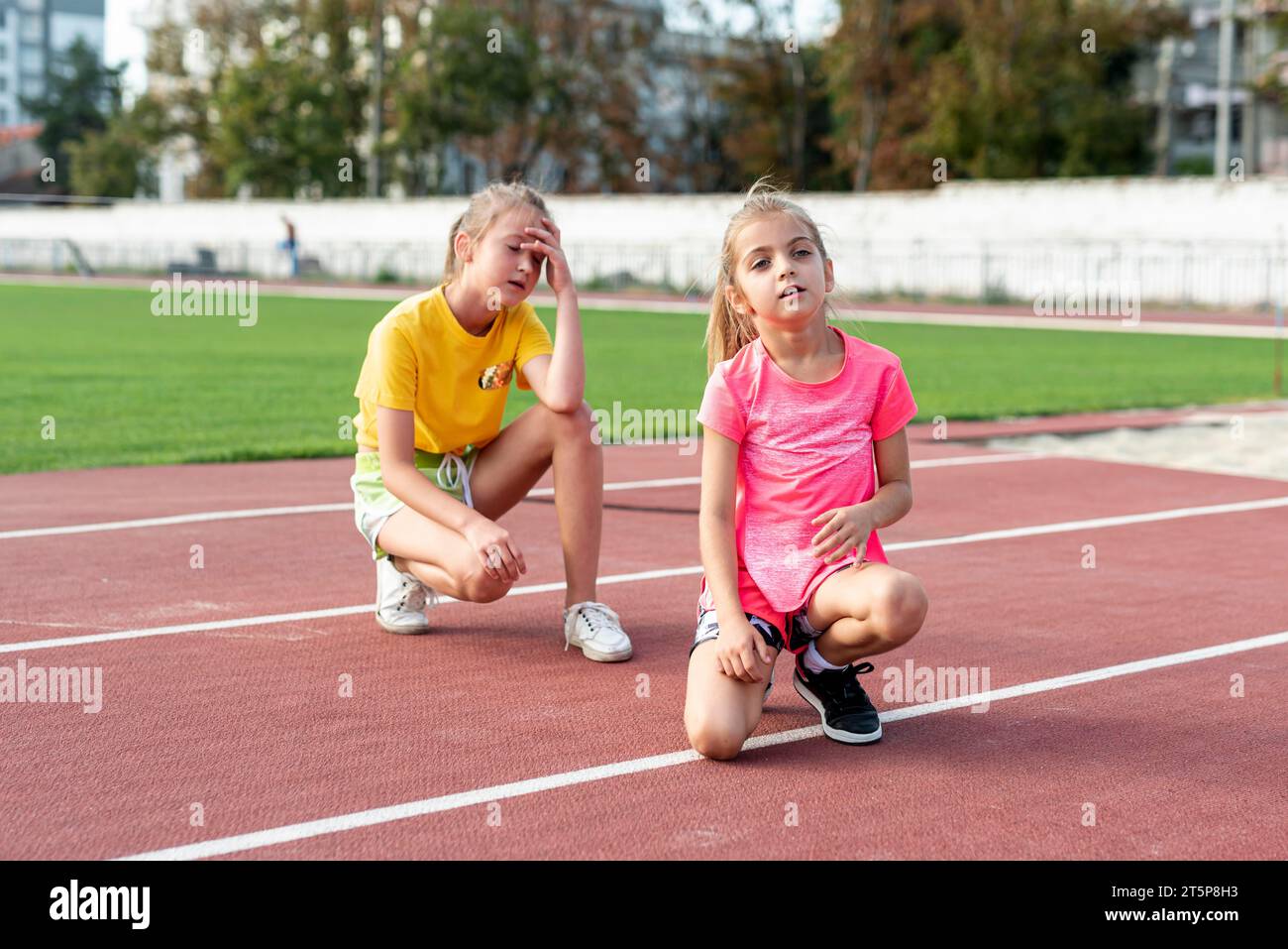 Front view girl running track Stock Photo - Alamy