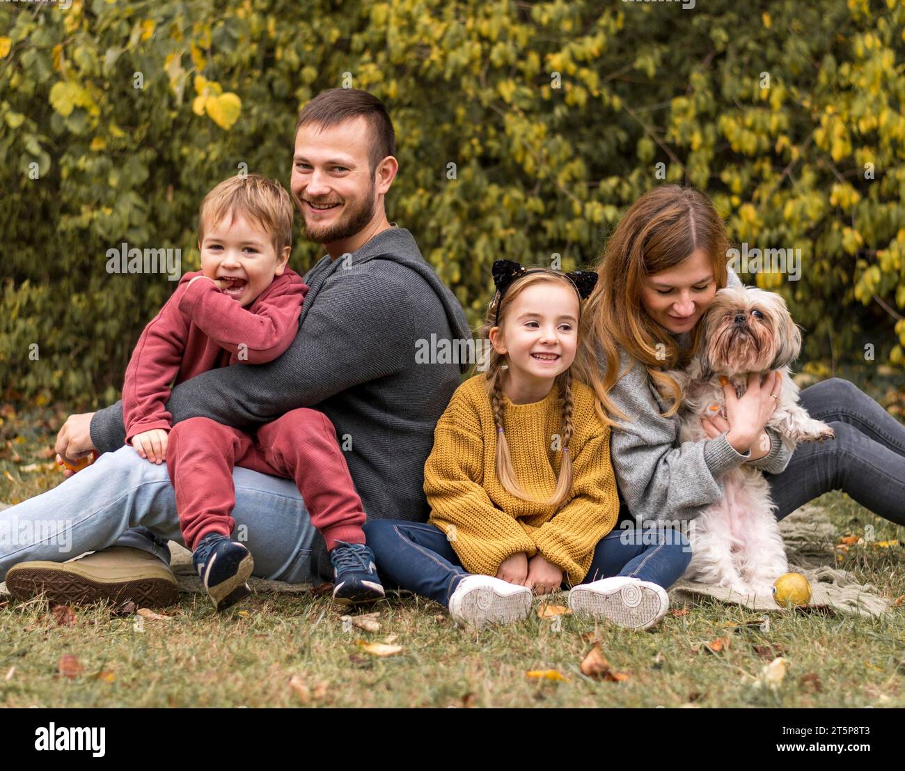 Happy family with dog outdoors Stock Photo - Alamy