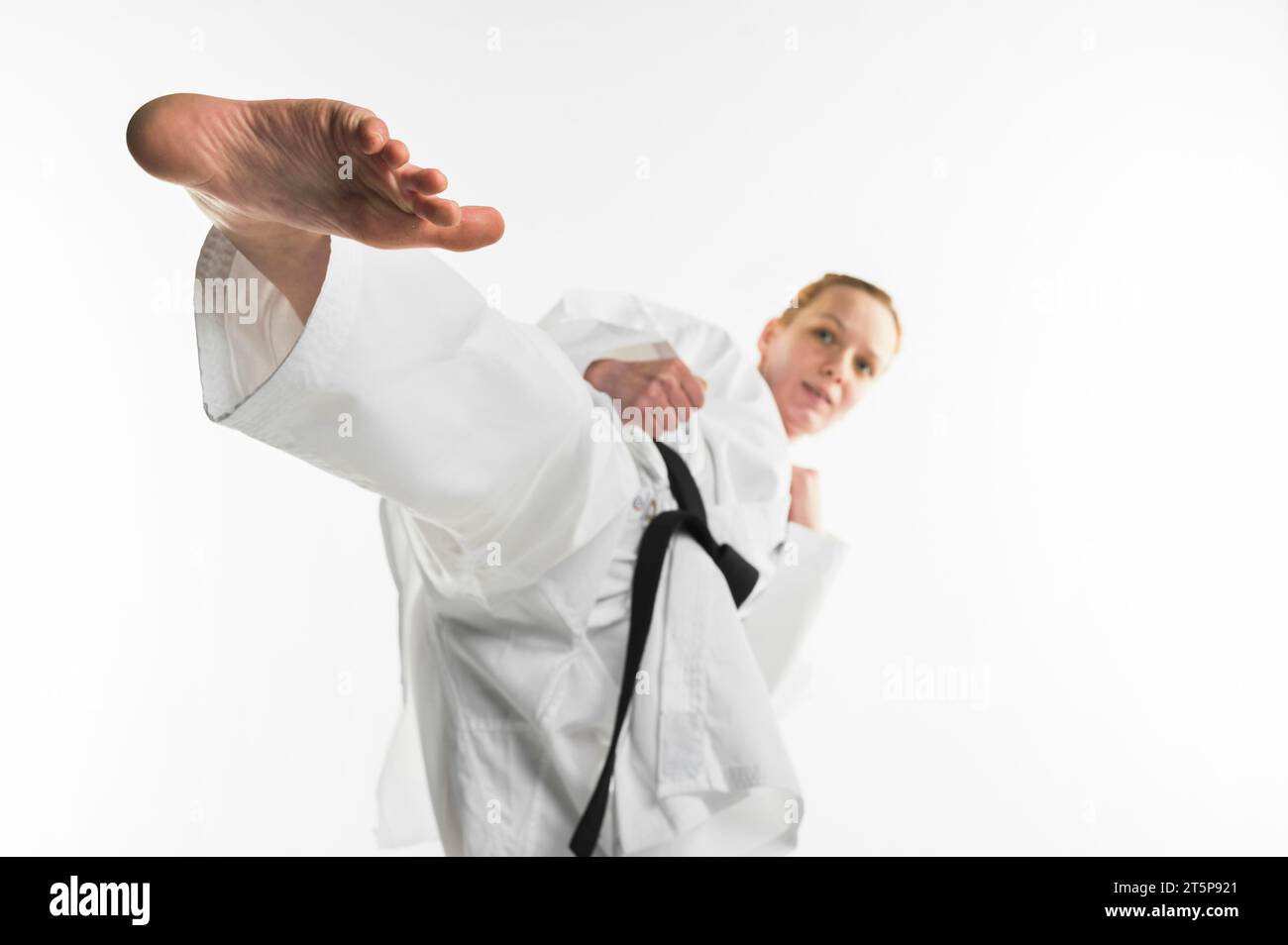 Karate fighter kicking with foot Stock Photo - Alamy