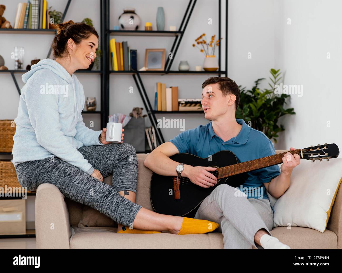 Medium shot people with guitar Stock Photo - Alamy