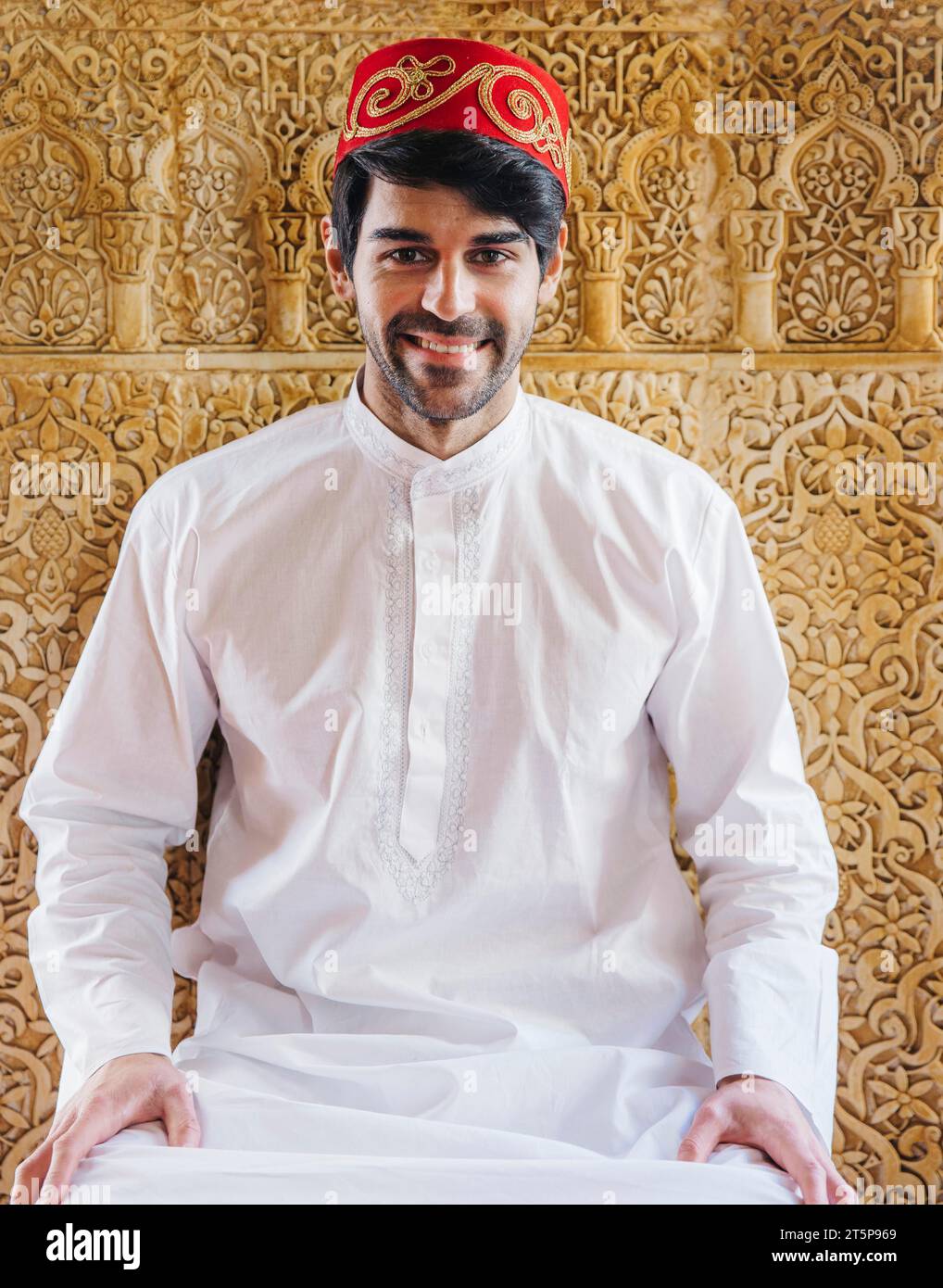 Muslim man front golden wall Stock Photo - Alamy