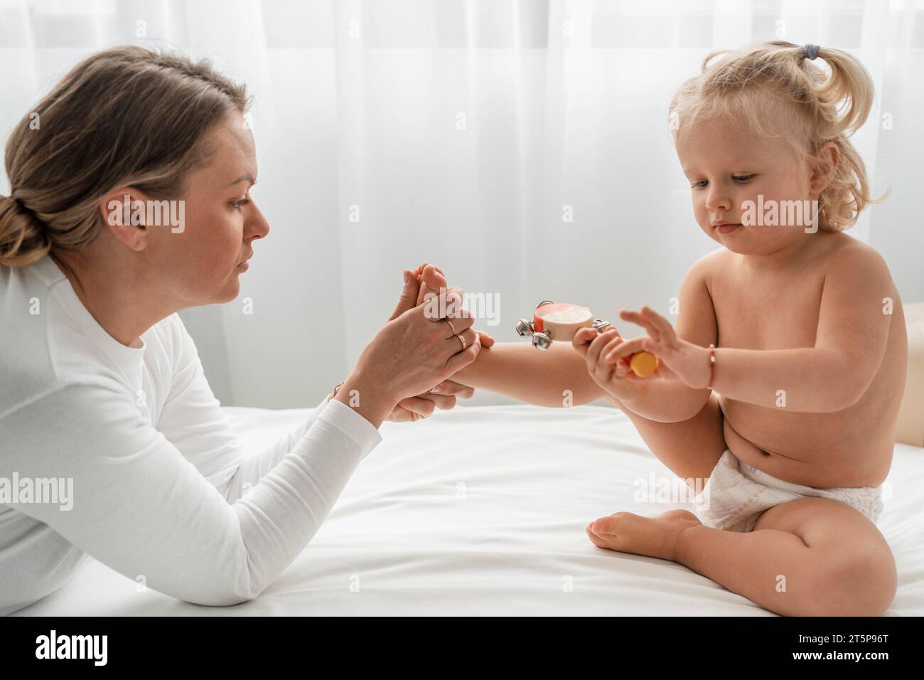 Female doctor treating an infant child hi-res stock photography and ...
