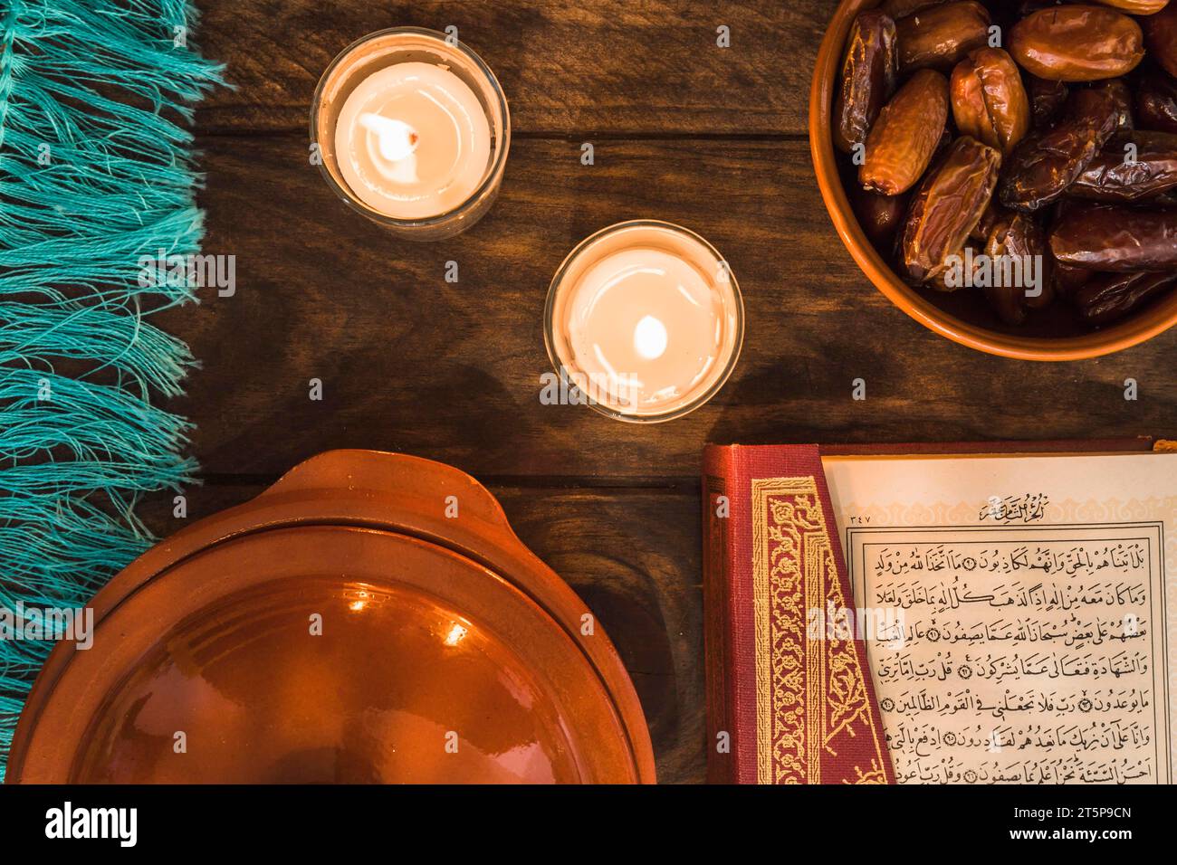 Quran dates near burning candles Stock Photo - Alamy