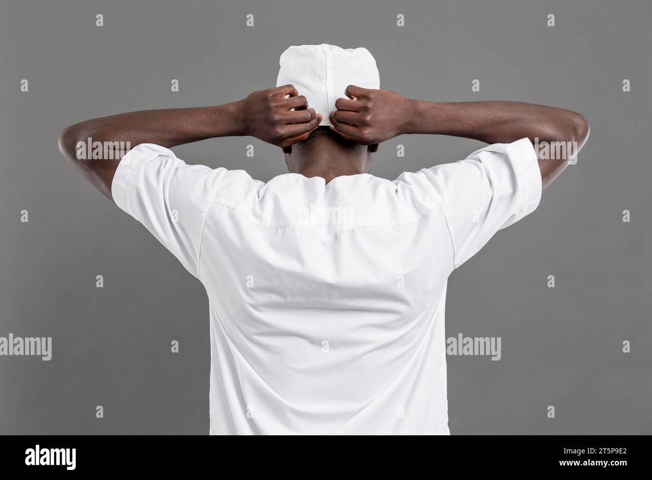 Professional young doctor adjusting his medical cap Stock Photo - Alamy