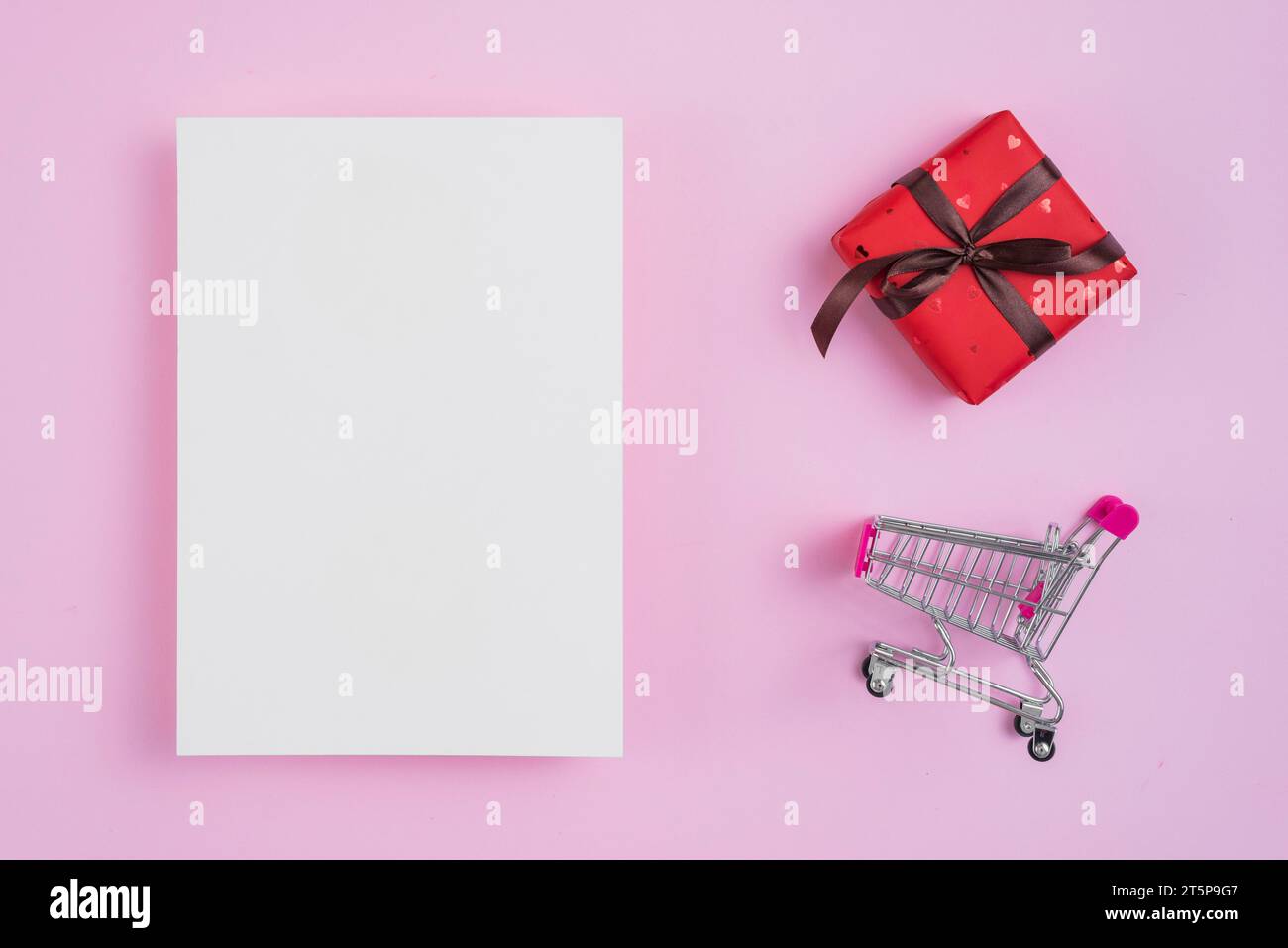 Shopping trolley gift near paper sheet Stock Photo - Alamy