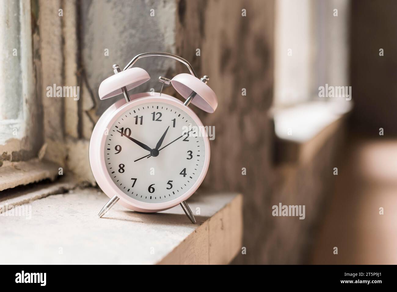 Small alarm clock wooden sill near window Stock Photo - Alamy