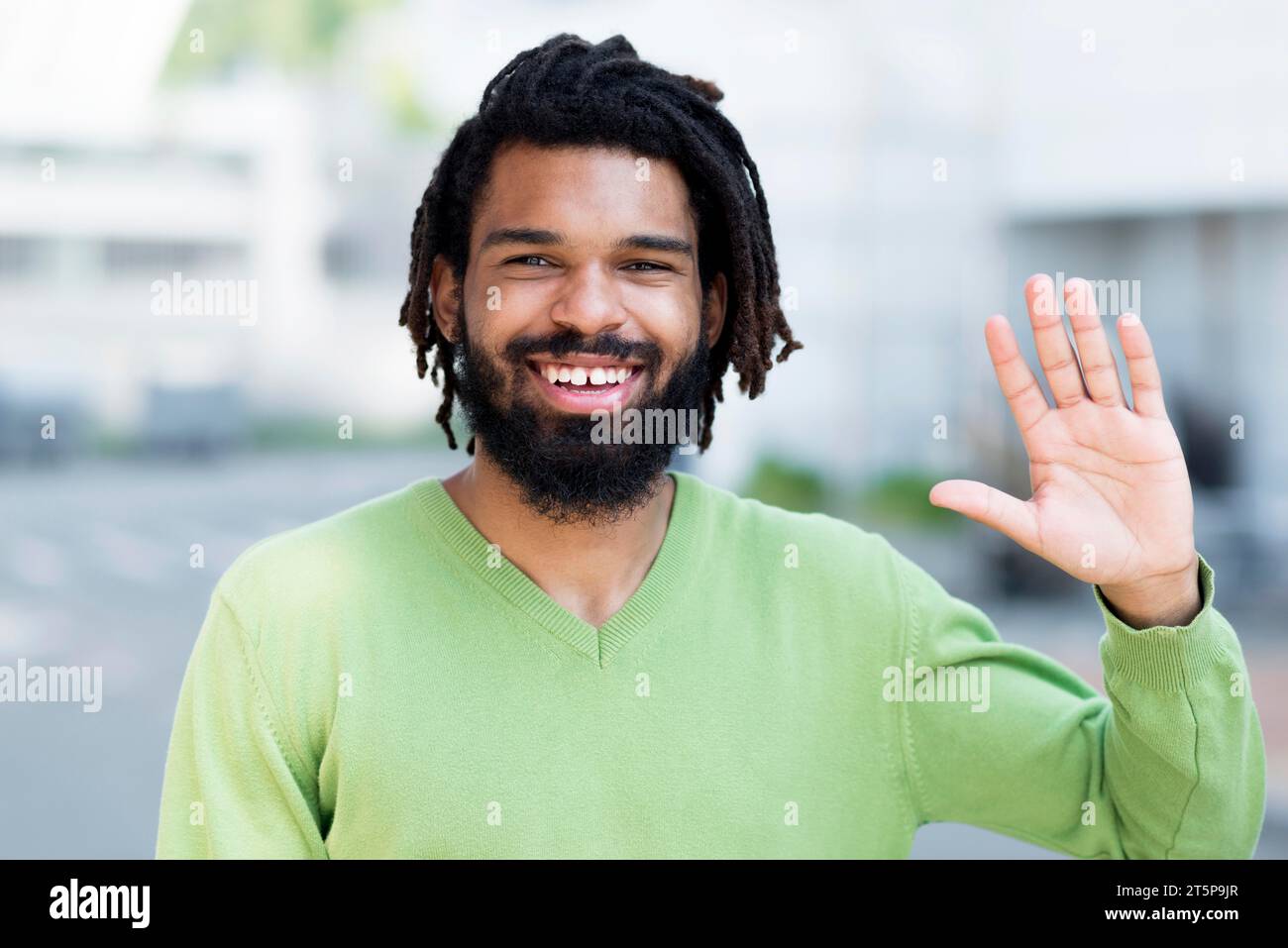 Smiley young person waving streets Stock Photo - Alamy