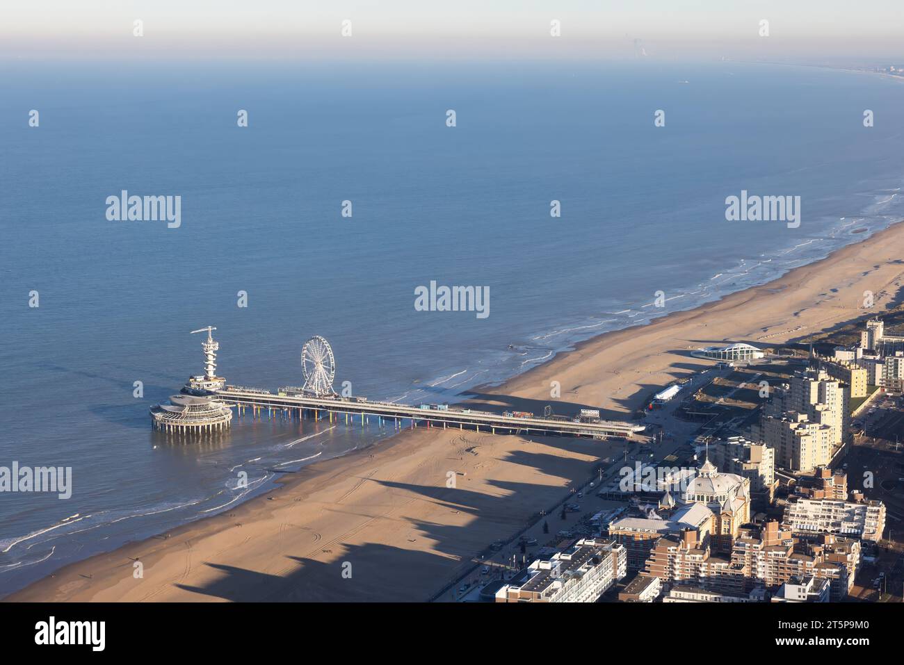 Dutch Scheveningen Pier with Ferris wheel at Dutch coast with long ...