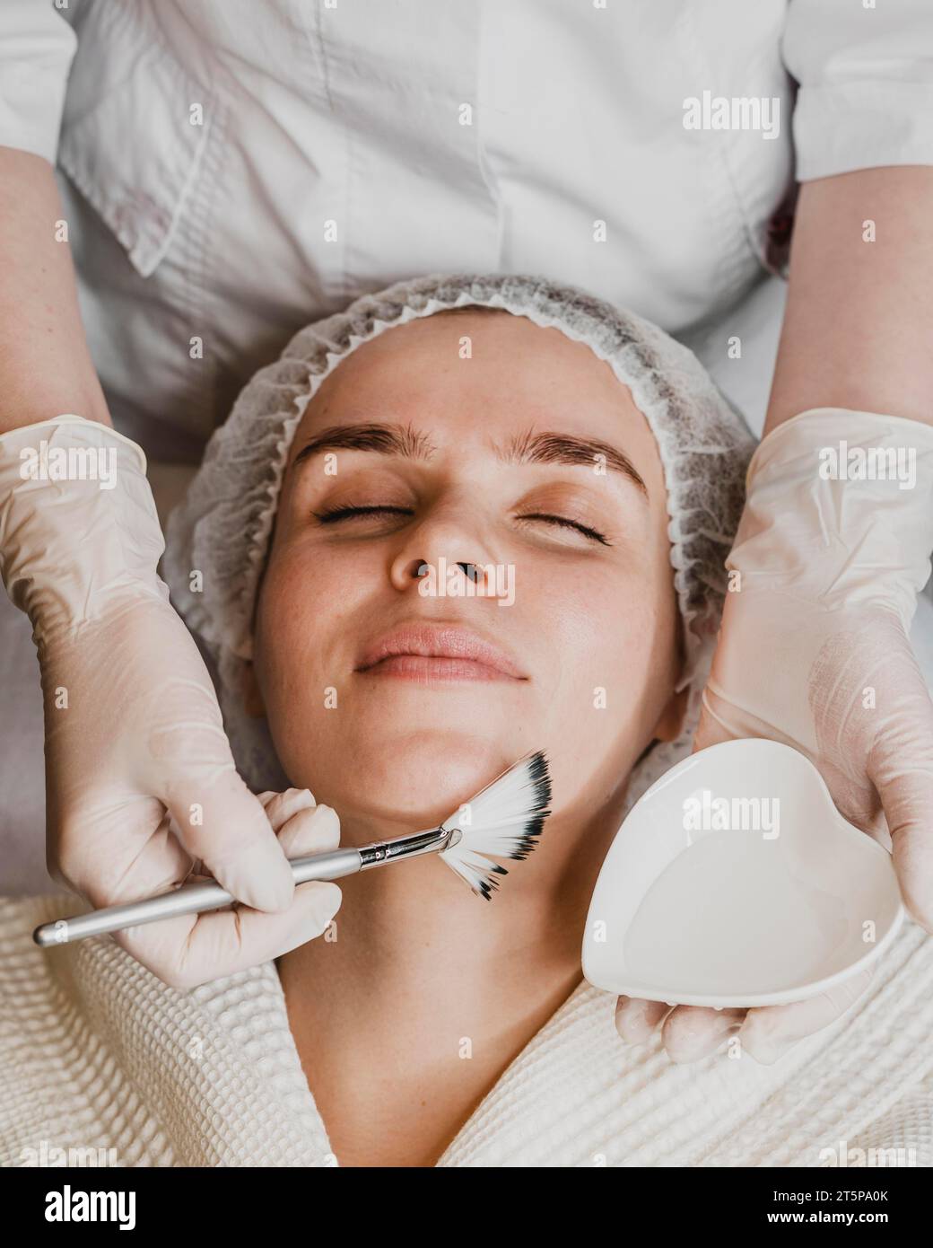 Top view young beautiful woman getting face skin treatment Stock Photo ...