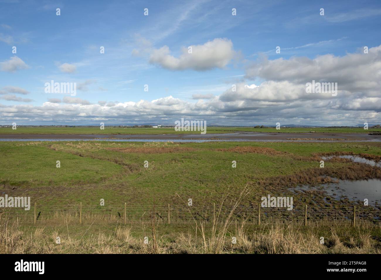 Waterlogged marsh by the River Douglas with a distant view to the ...