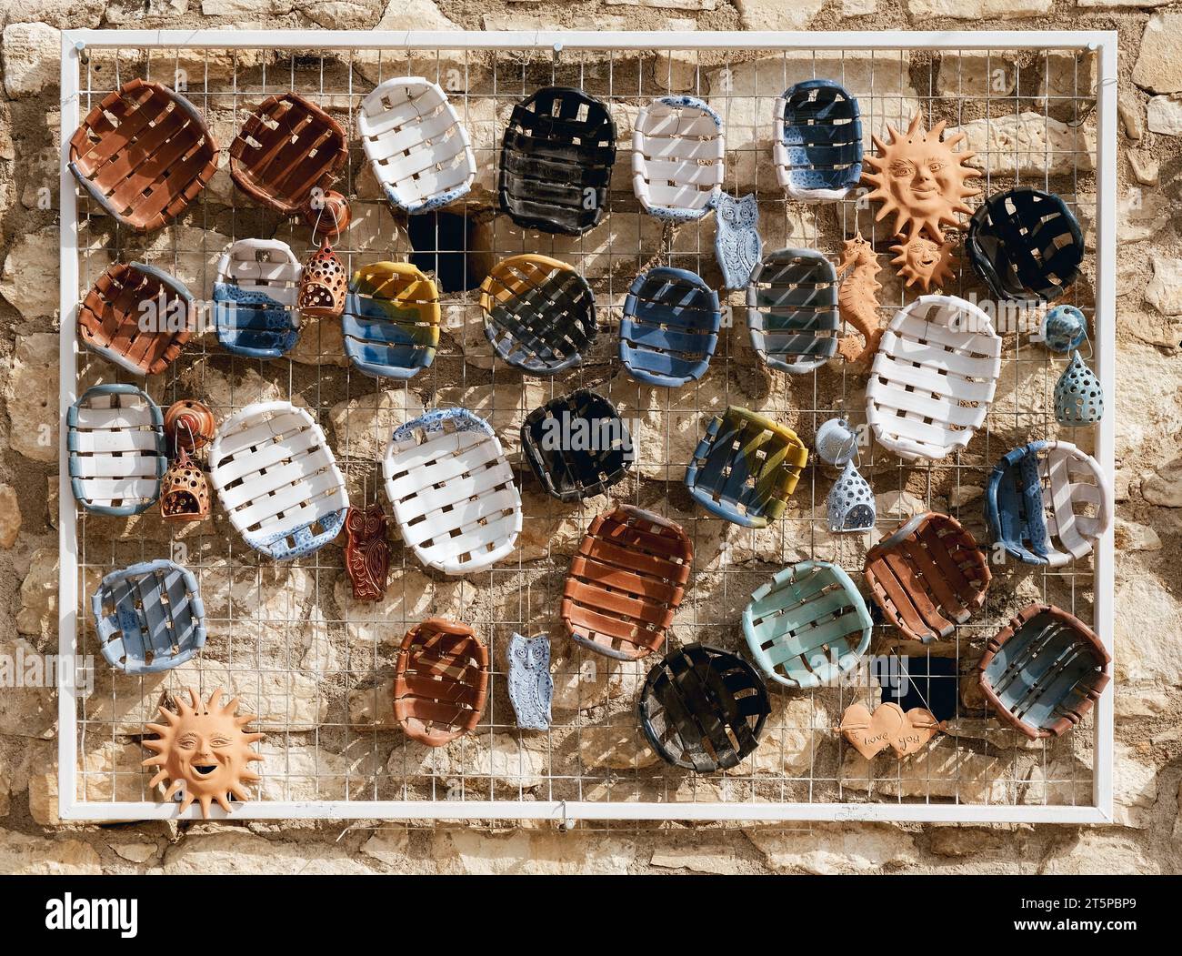Traditional Greek ceramics on display on old stone wall in Crete Stock ...