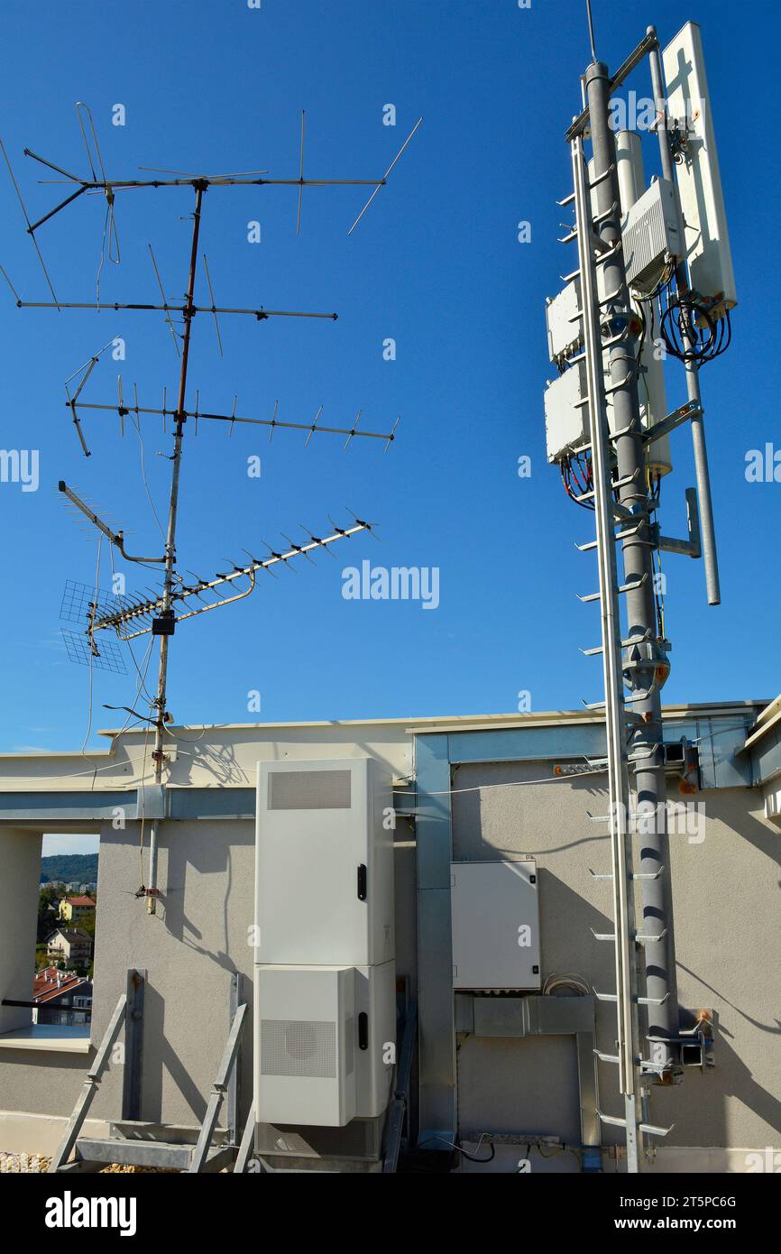 4G and 5G cellular antennas on the flat roof of a high rise building in ...