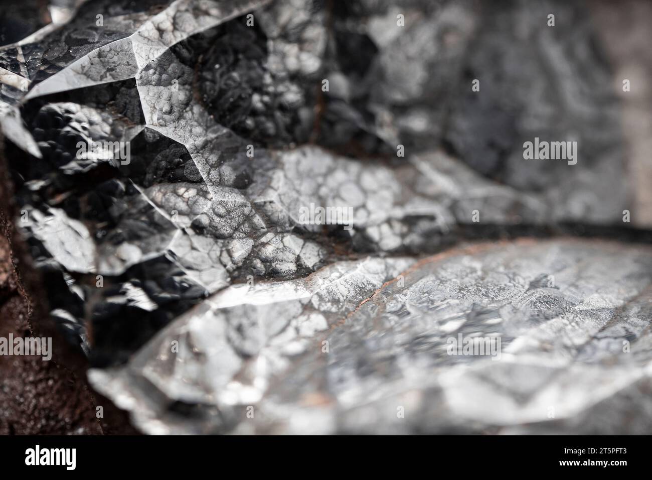 Metal rock texture. Close up of a raw hematite stone. Shiny mineral ...
