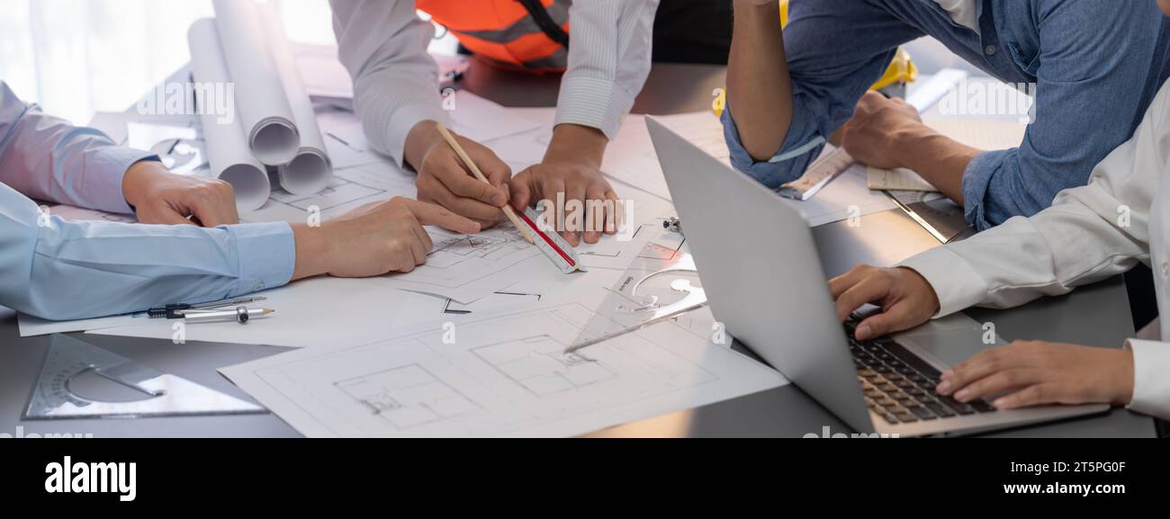 Architect or engineer working on building blueprint, contractor ...