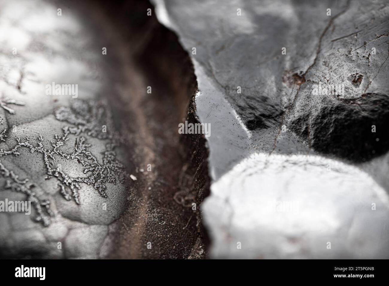 Metal rock texture. Close up of a raw hematite stone. Shiny mineral ...
