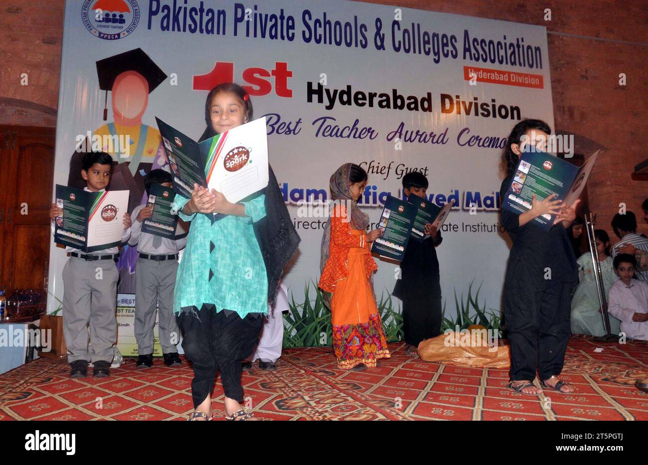 Students are presenting tableau on stage during the Best Teacher Award ...