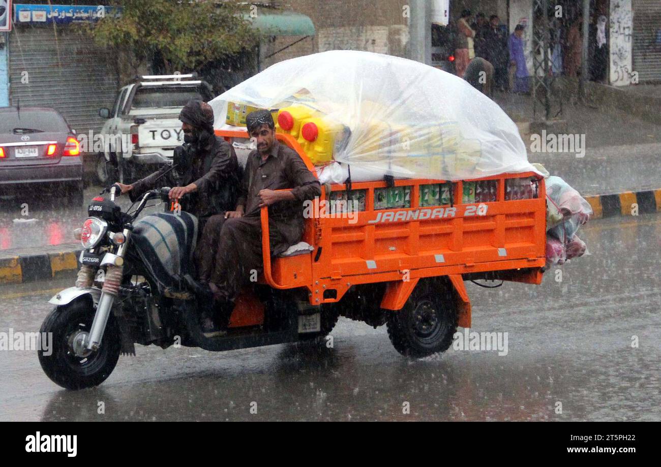 A rickshaw driver is using plastic sheet to covered his rickshaw from ...