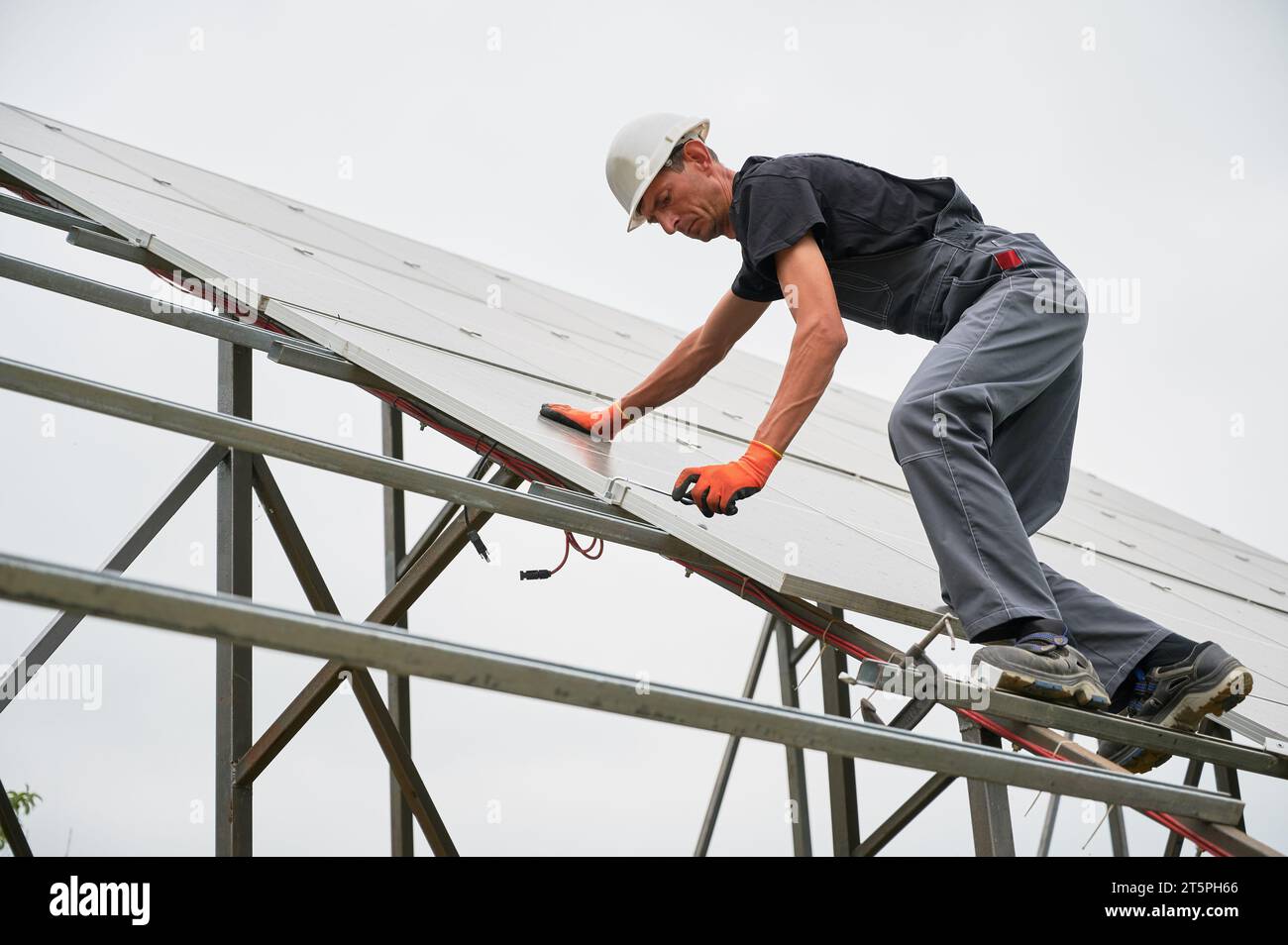 Man technician building photovoltaic solar panels. Male worker in ...