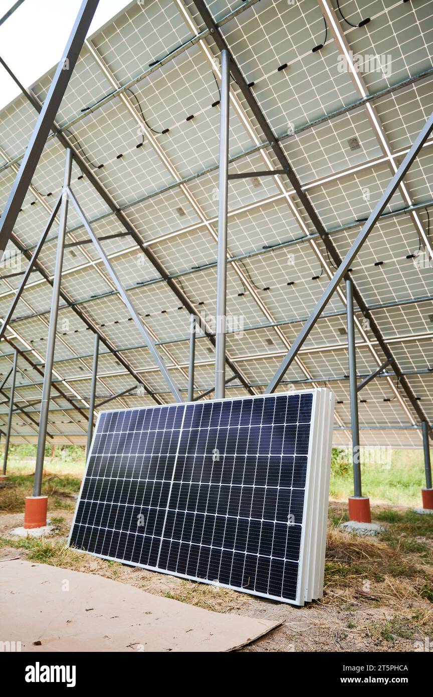Set of solar panels under solar energy system on metal beams in field ...