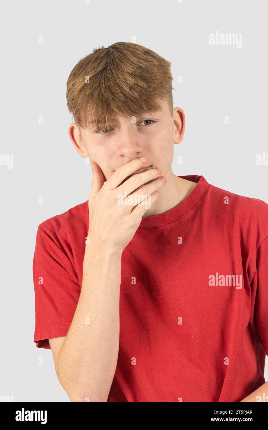 A studio portrait of a nervous fifteen year old teenage boy Stock Photo ...