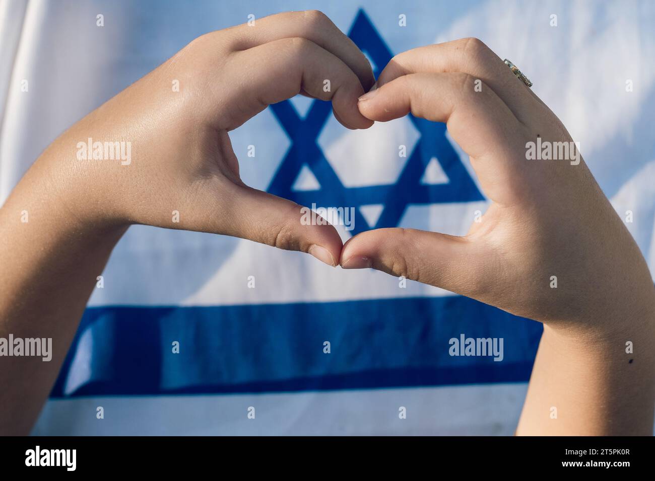 Heartfelt Gesture. Child Forms a Heart with Hands, Framing Magen David ...