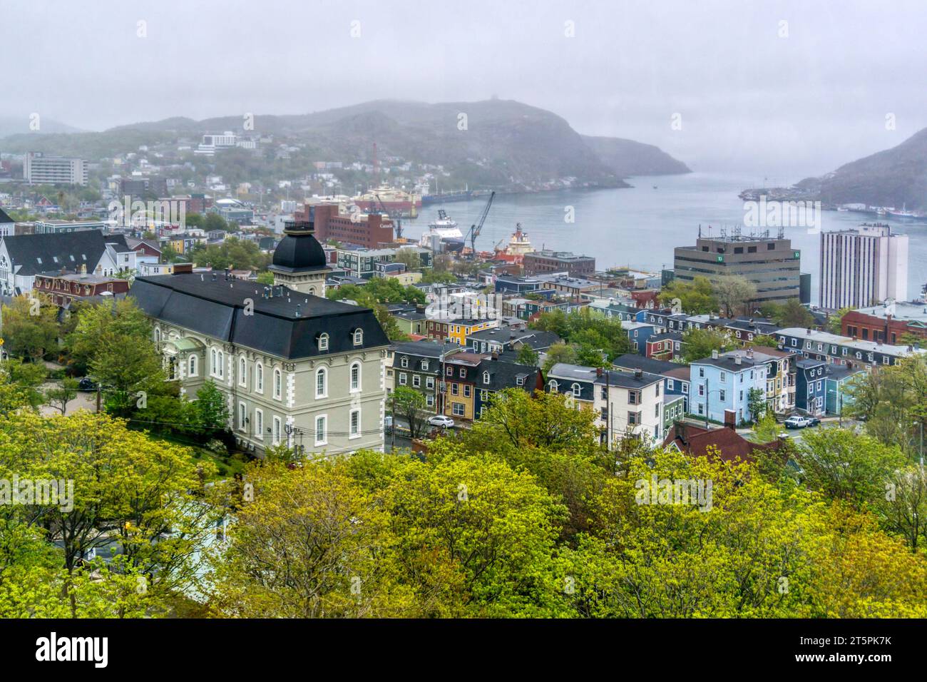 View over the city and port of St Johns, Newfoundland, on a misty ...