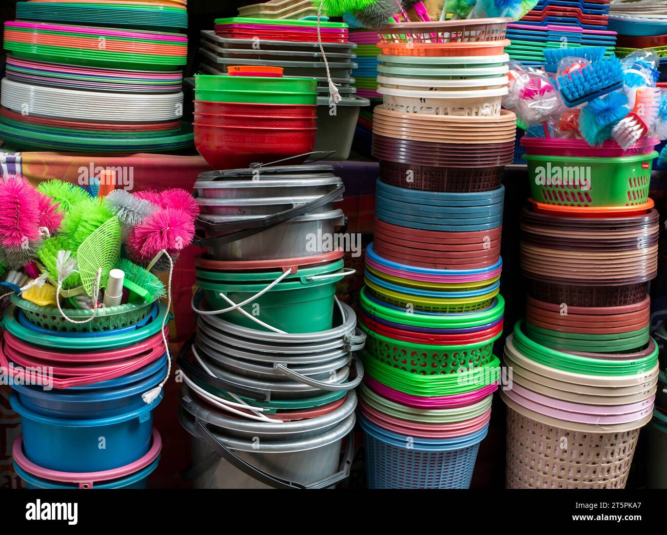 A stack of colorful plastic buckets and containers in traditional ...