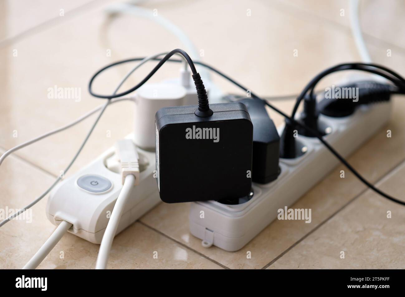 Overloaded power boards. Power strips with different electrical plugs ...