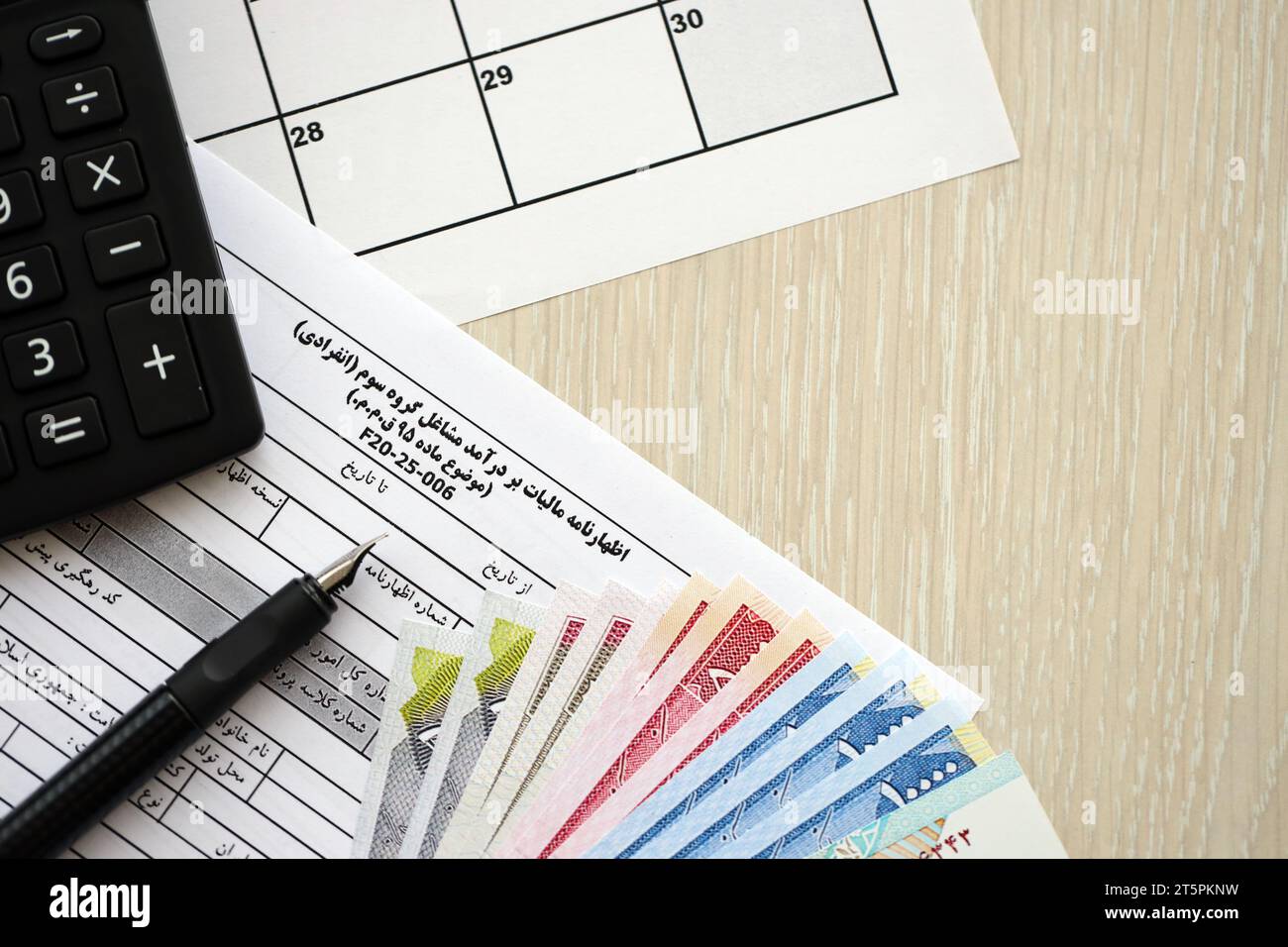Iranian annual income tax return form F20-25-006 ready to fill on table ...