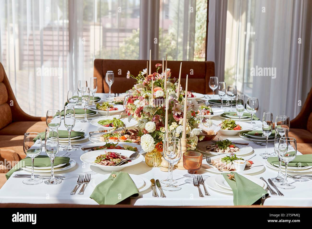 Elegant chamber table setting with candles and flowers arrangement ...