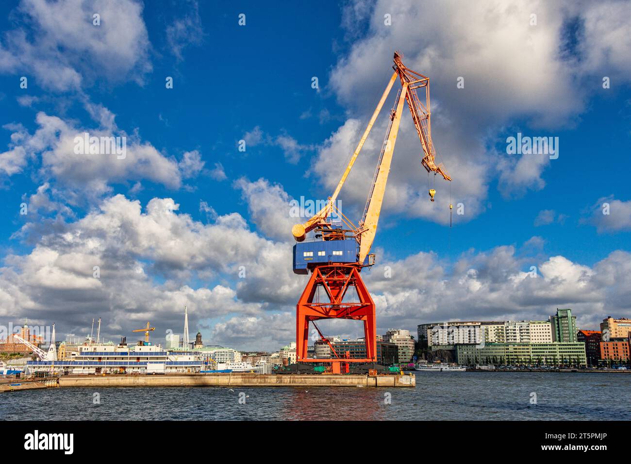 Cranes loading and unloading containers from commercial ships at Gothenburg cargo port ...