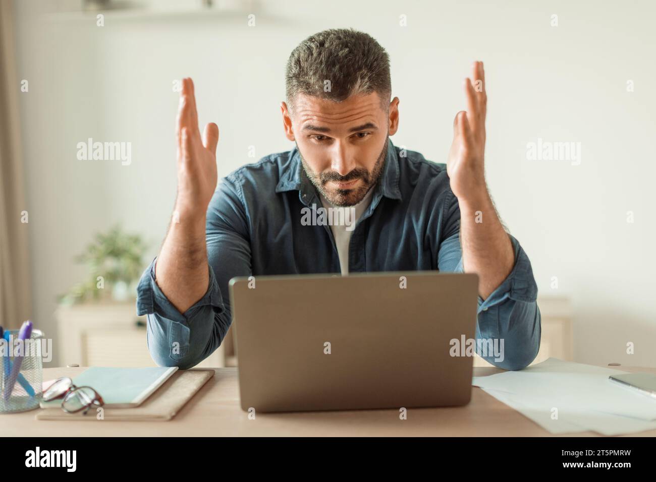 man managing work through laptop having issues in office Stock Photo ...