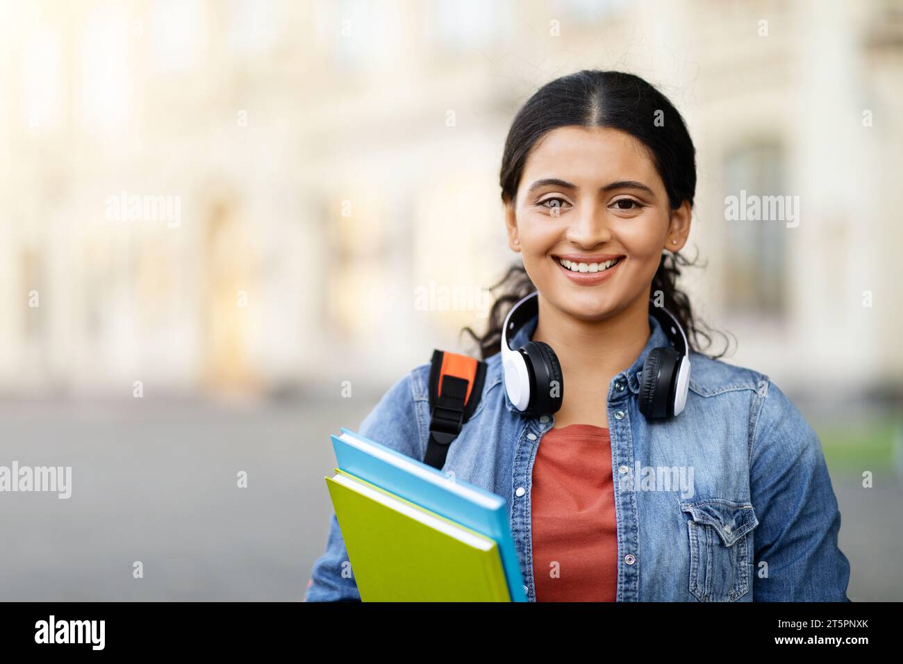 Closeup pretty young indian lady student posing at university campus ...