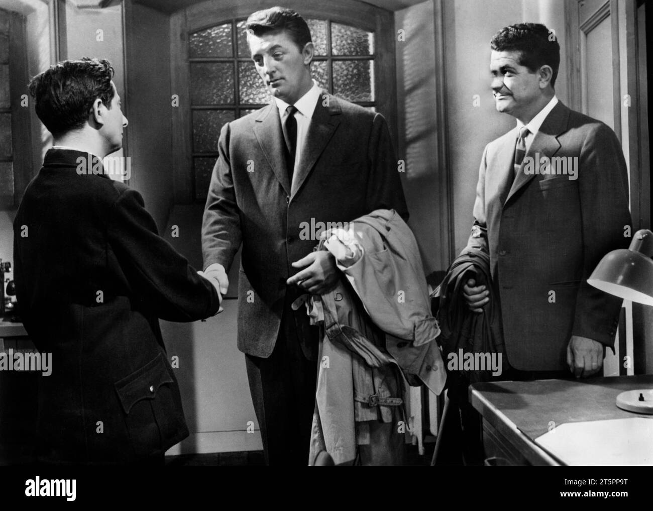 Robert Mitchum (center), on-set of the film, "Foreign Intrigue", United ...