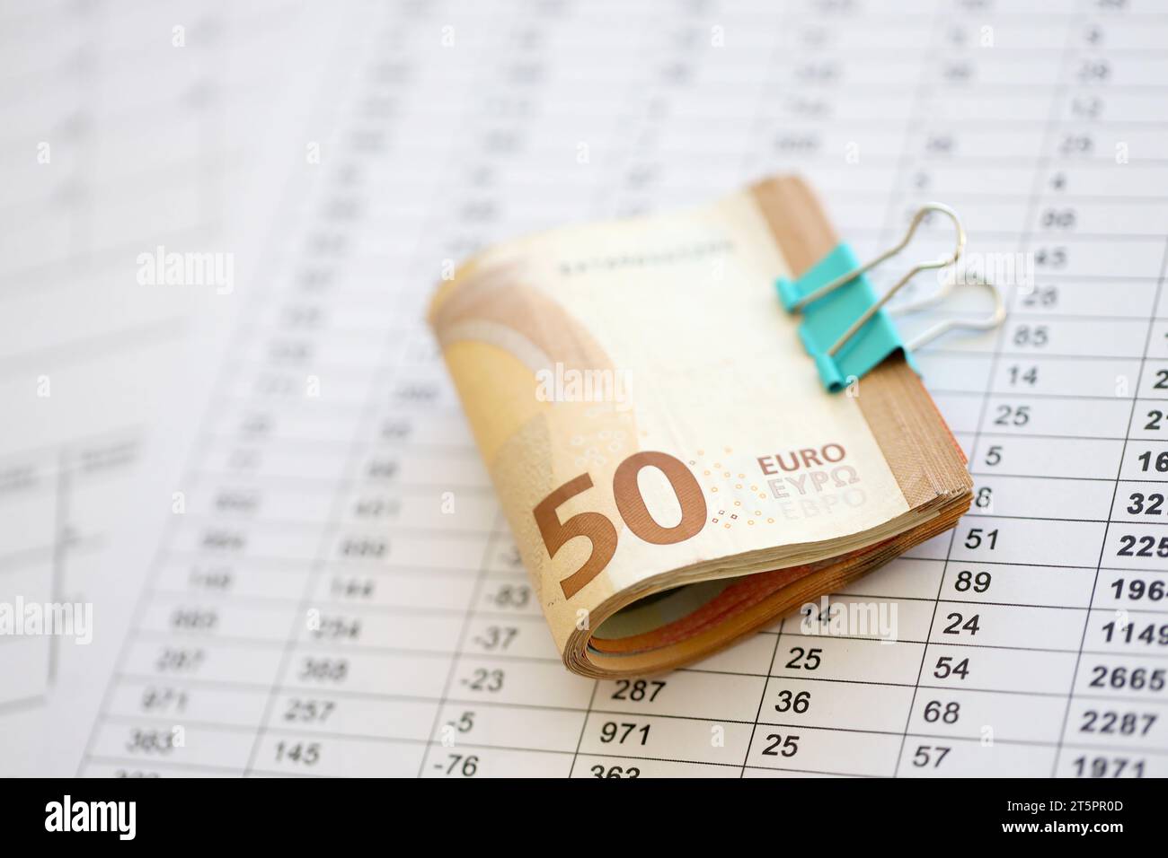 Heap of euro money bills in stationery clip on papers with calculations ...