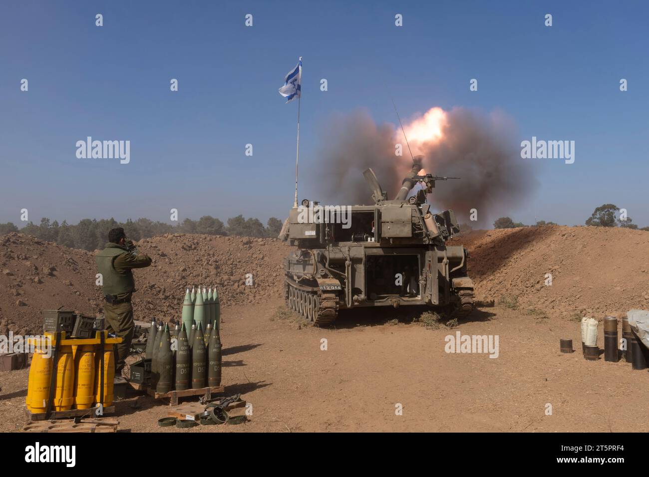 An Israeli mobile artillery unit fires a shell from southern Israel ...